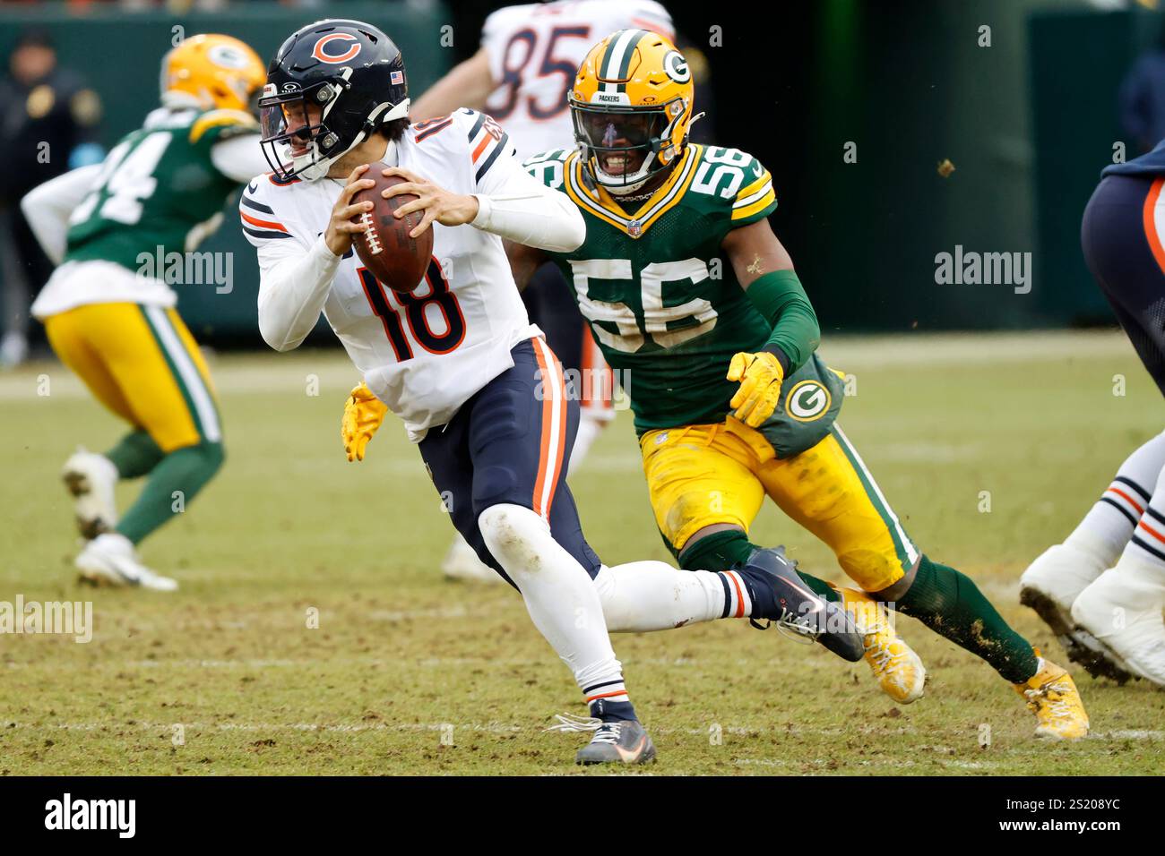 Chicago Bears quarterback Caleb Williams (18) scrambles away from Green ...