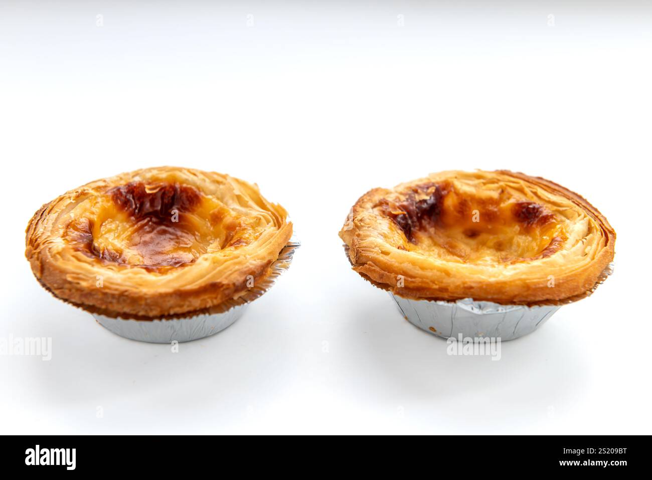 Two baked egg tarts isolated on white Stock Photo - Alamy