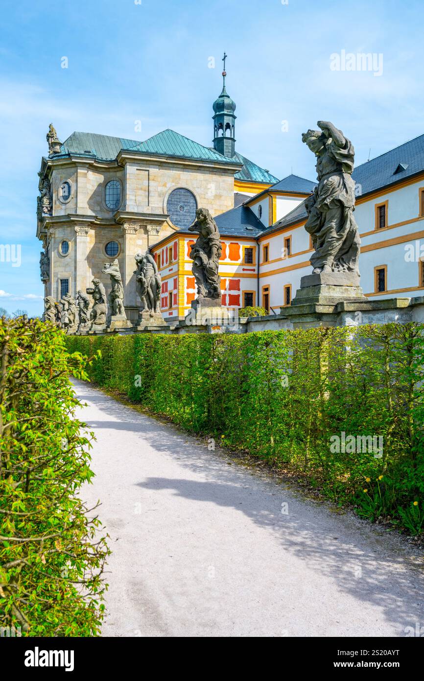 Tall Baroque statues stand along a walkway at the Kuks hospital complex ...