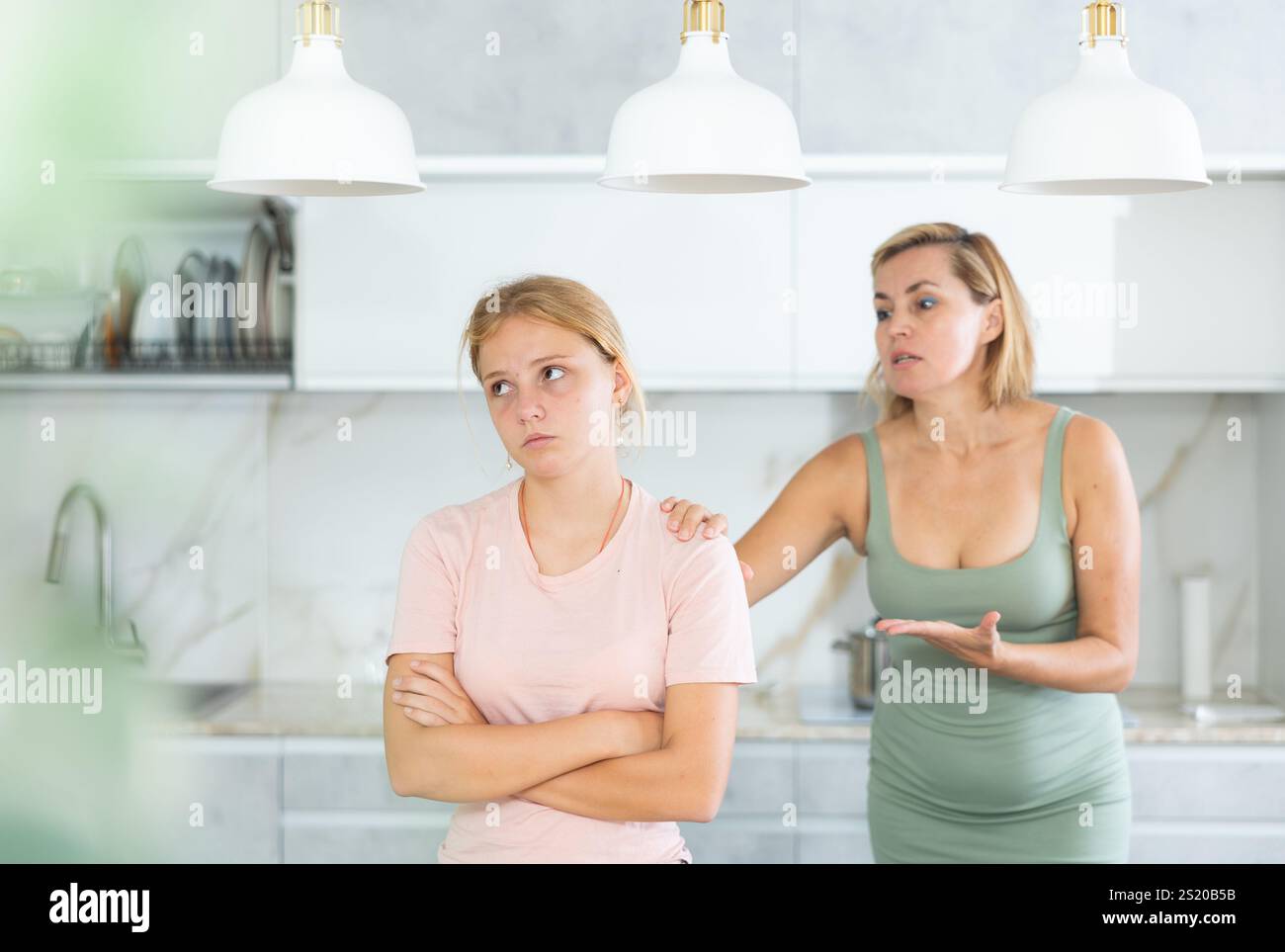 Angry mother yells at teenage girl sad daughter Stock Photo - Alamy