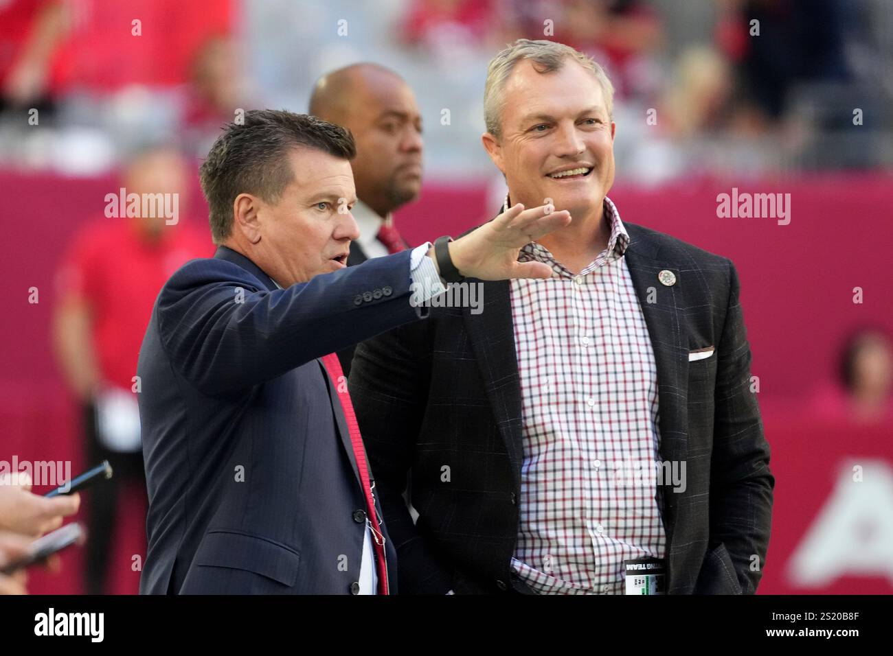 Arizona Cardinals owner Michael Bidwell, left, talks with San Francisco ...