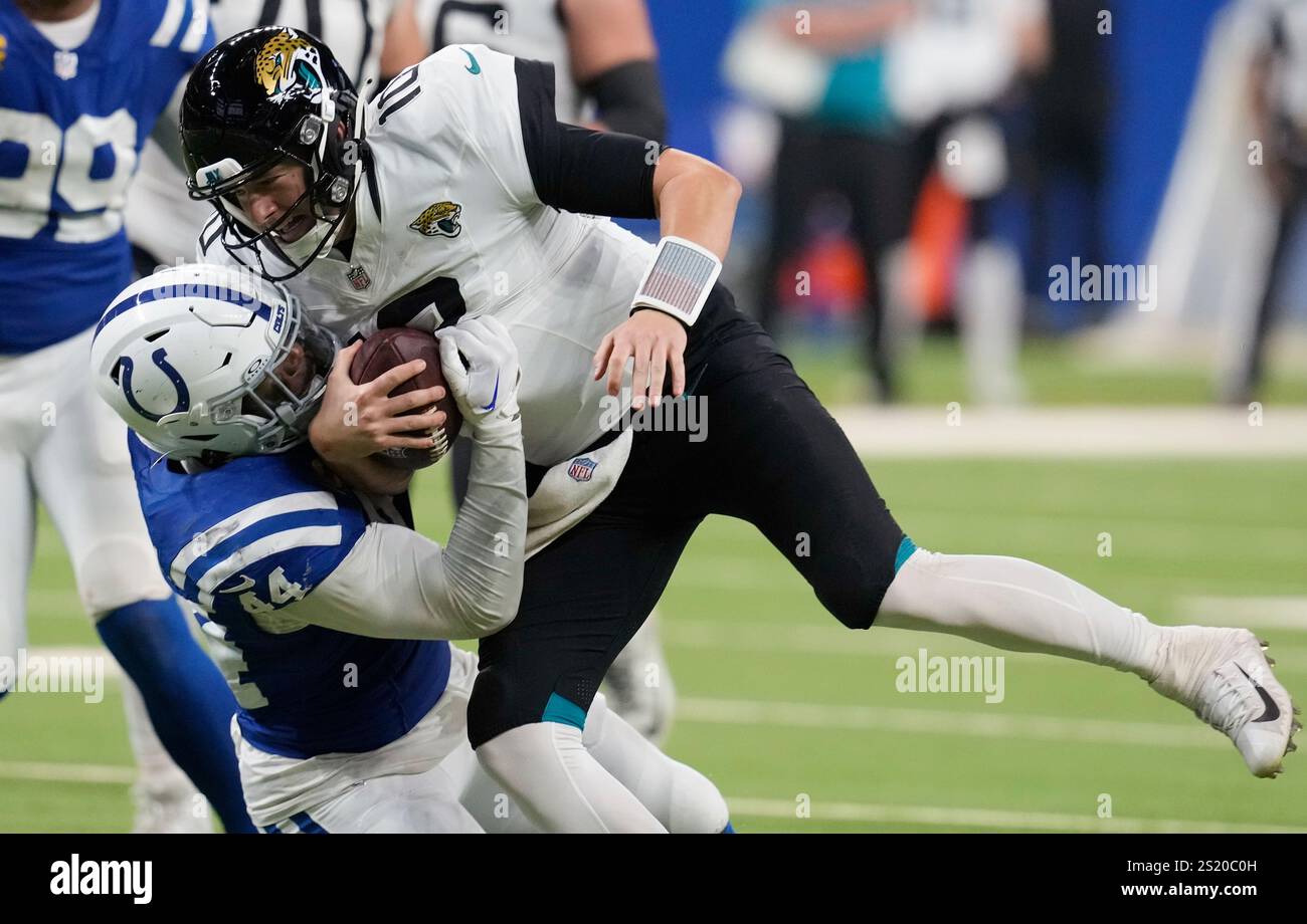 Jacksonville Jaguars quarterback Mac Jones (10) is sacked by Indianapolis Colts linebacker Zaire ...