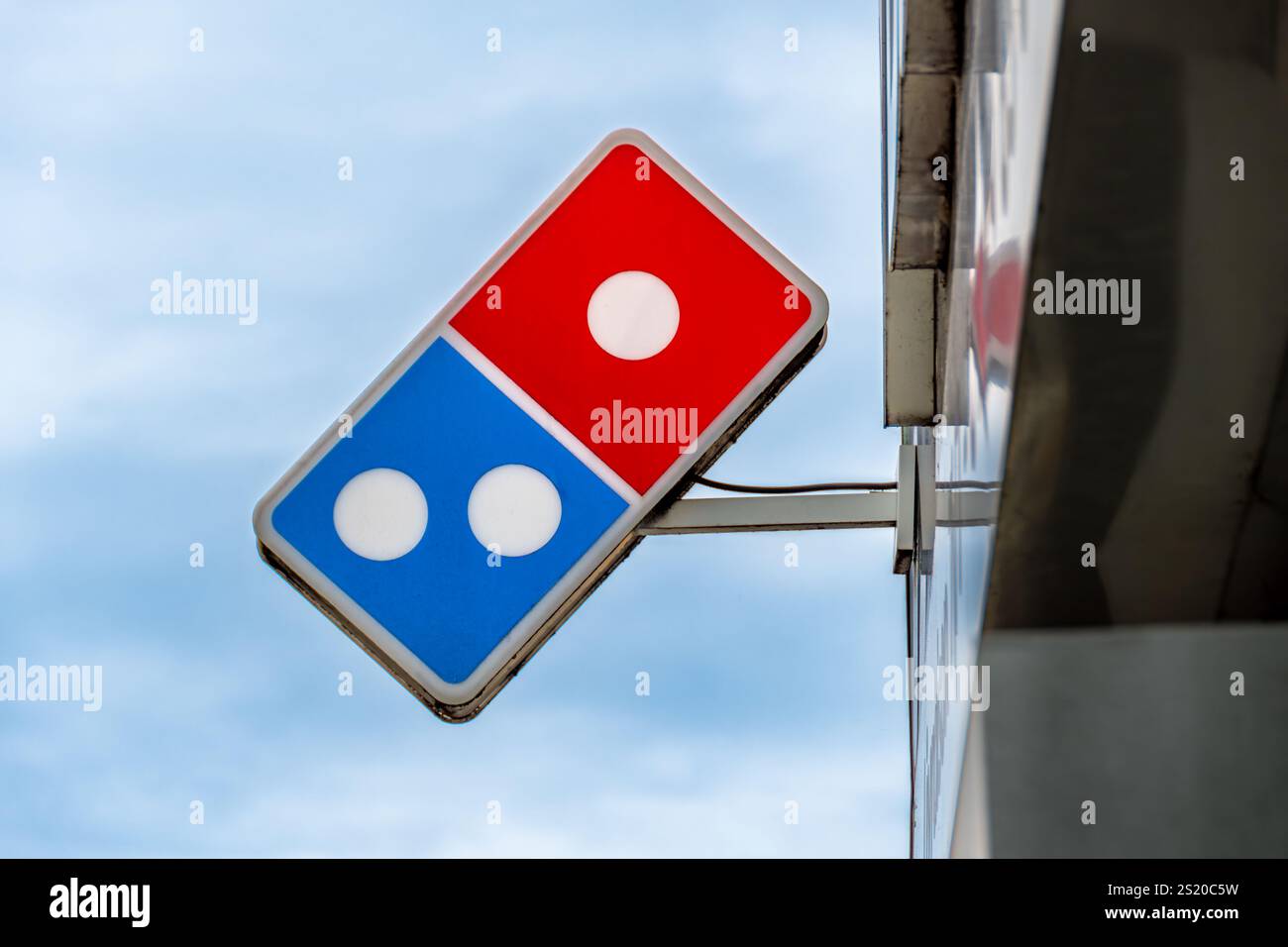 Sign and logo of a Domino's restaurant. Domino's Pizza is an American ...
