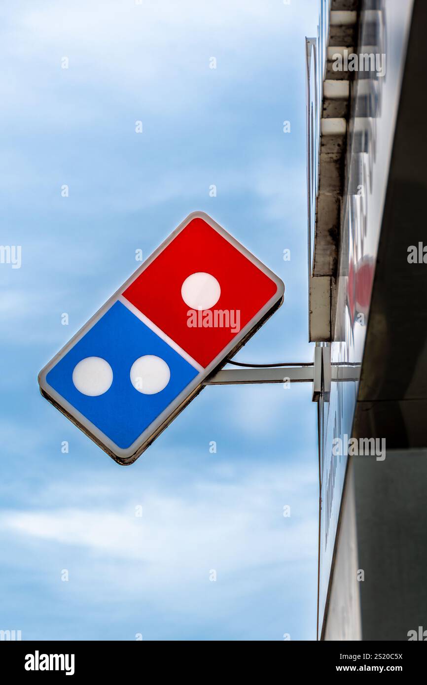 Sign and logo of a Domino's restaurant. Domino's Pizza is an American ...