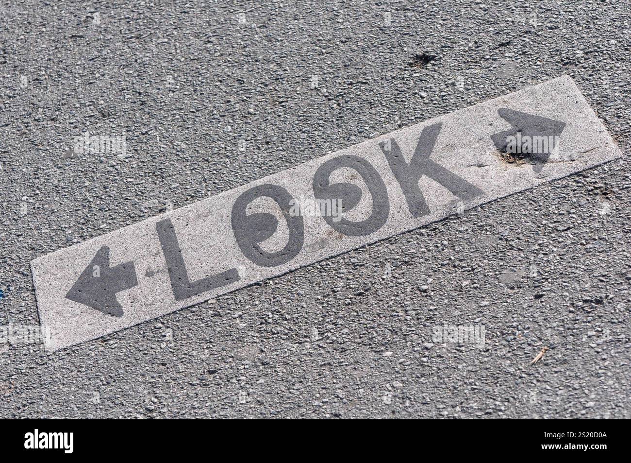 Pedestrian safety: 'LOOK' sign with arrows on textured asphalt Stock ...