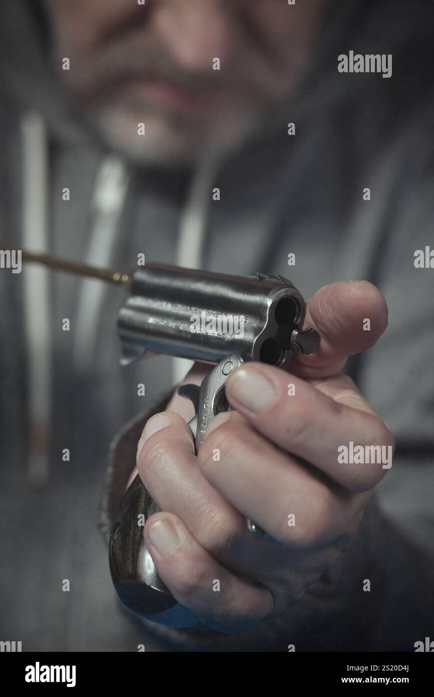 Man take care of two barrel derringer personal handgun caliber .38 ...