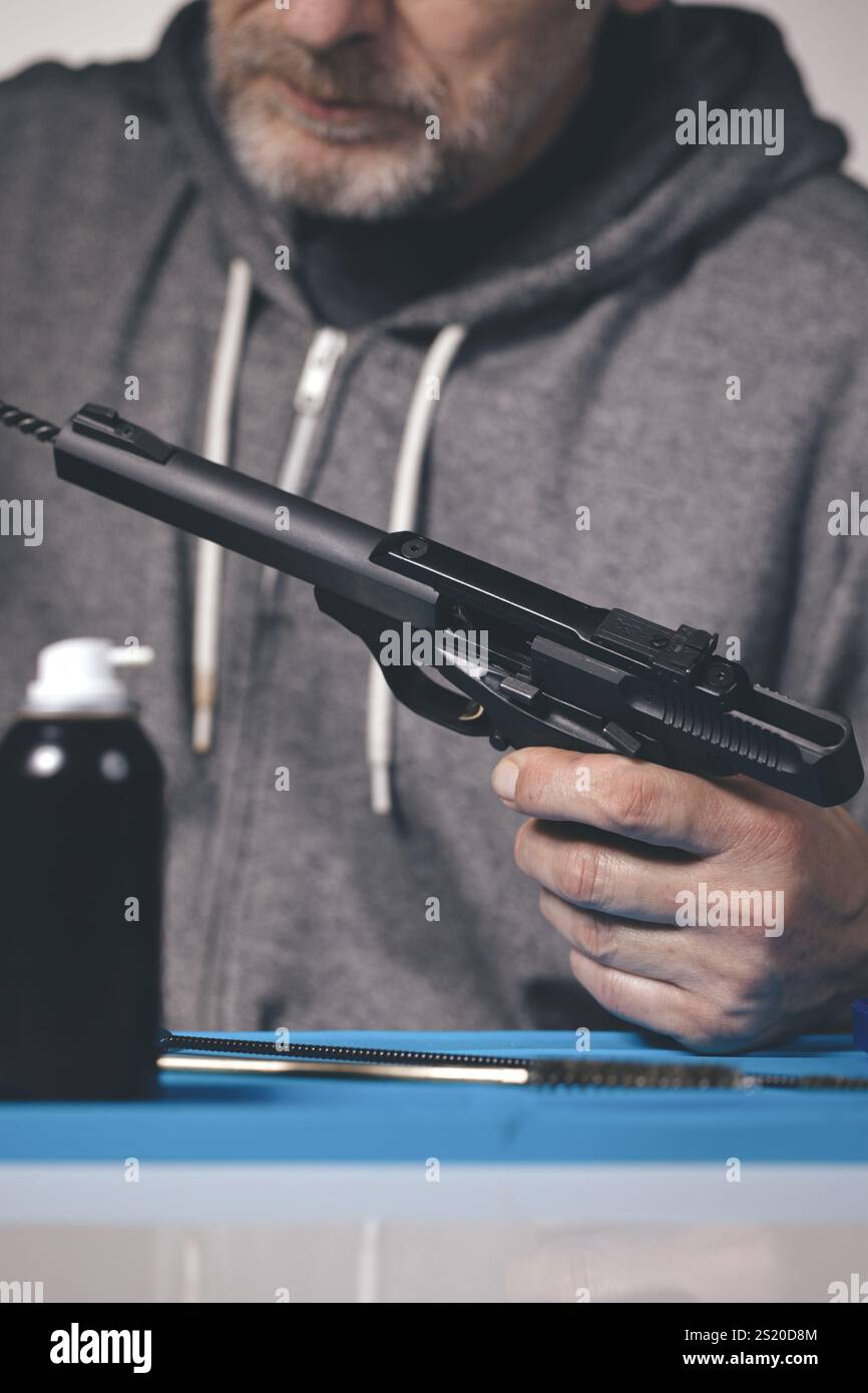 Man take care of small caliber semi automatic sporting gun .22 LR Stock ...