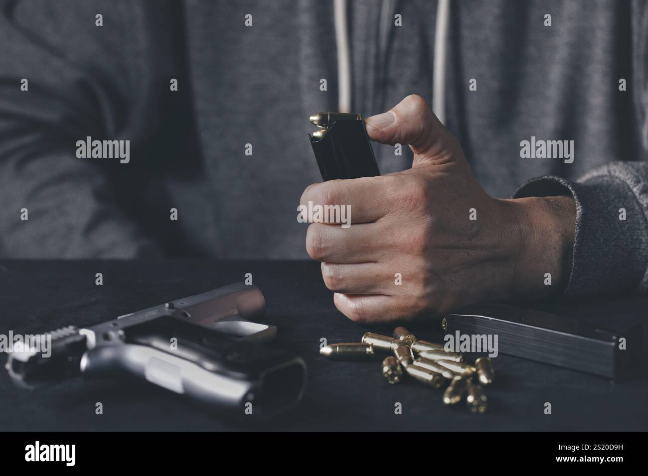 Man loading mgazine of semi automatic pistol handgun at home Stock ...