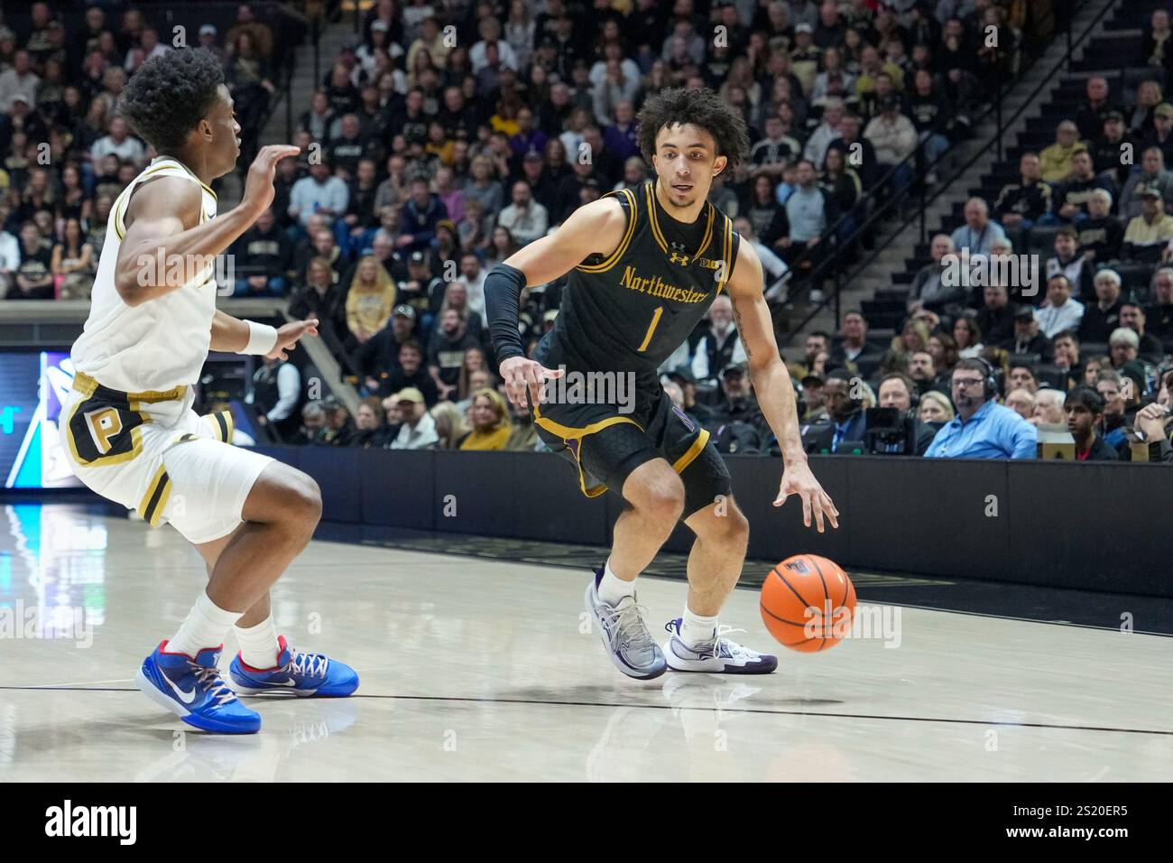 Northwestern guard Jalen Leach (1) goes around Purdue guard Myles ...