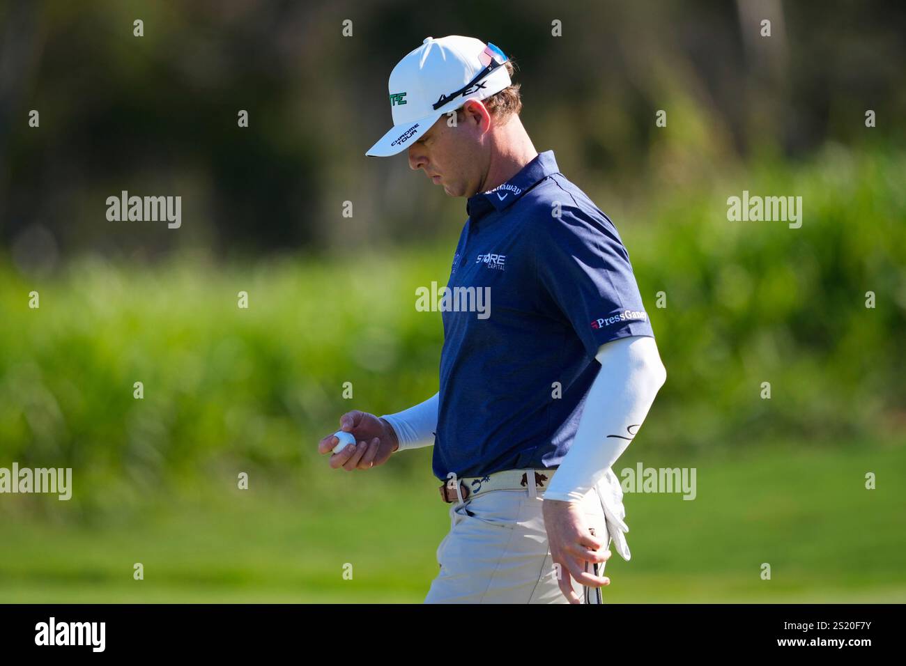 Max Greyserman looks at his ball after missing a shot on the fourth ...
