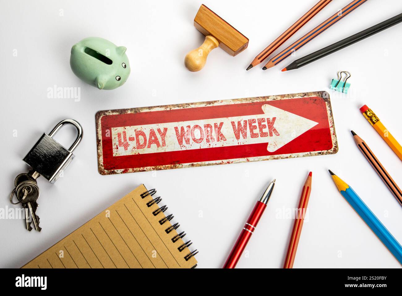 4-day work week. Red direction arrow with text on white office desk ...