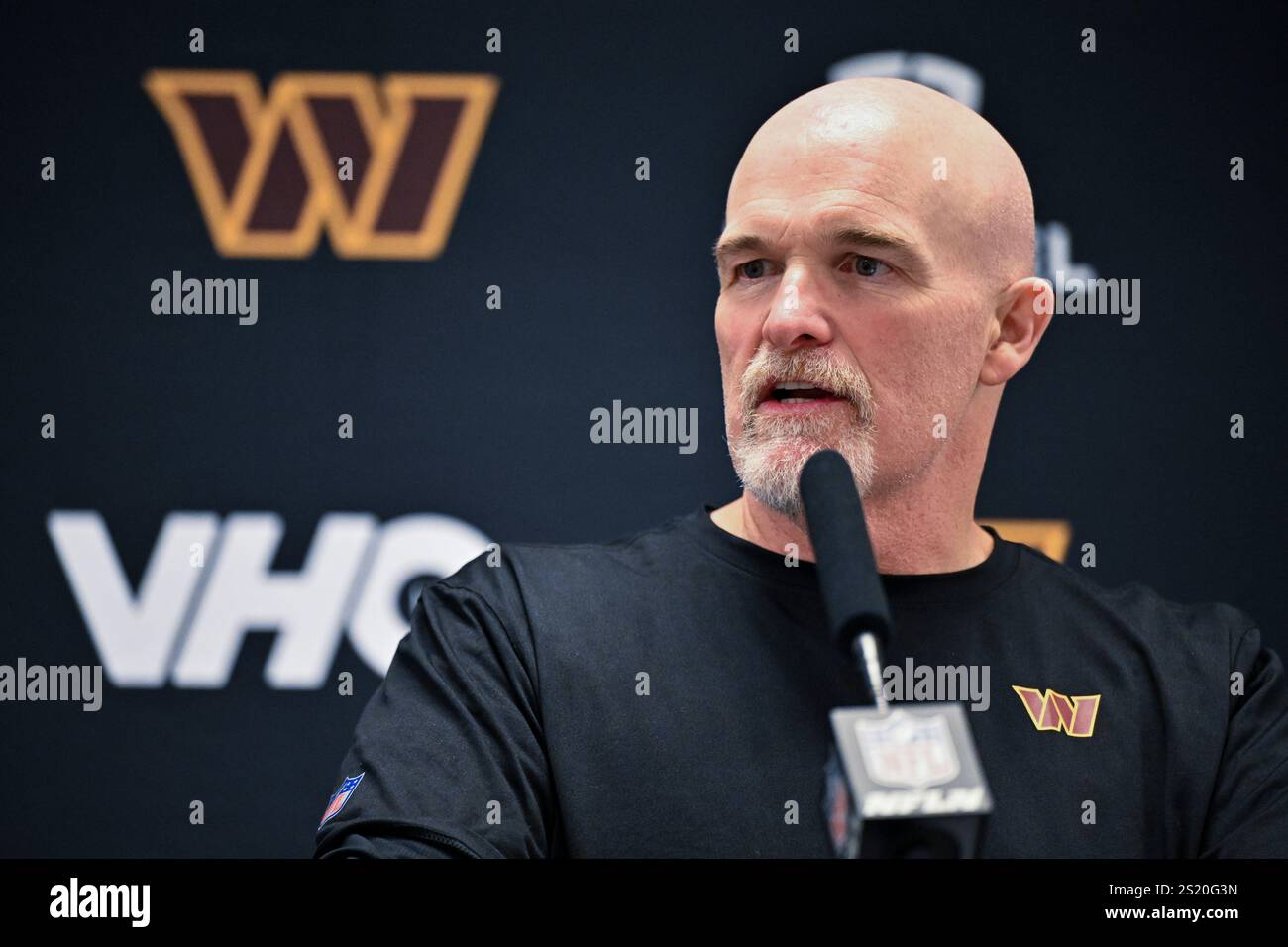 Washington Commanders head coach Dan Quinn talks to reporters following ...