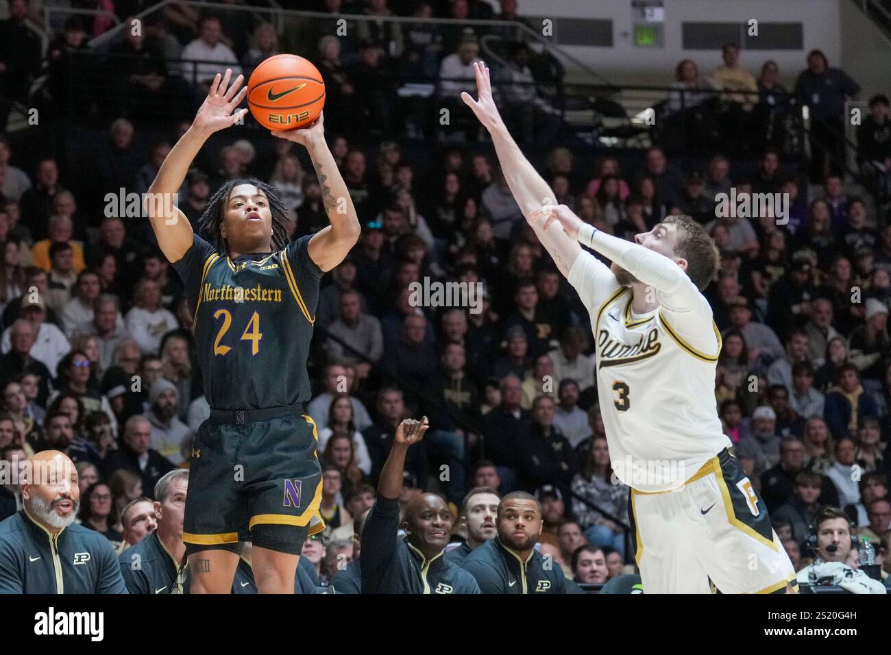 Northwestern guard K.J. Windham (24) looks to shoot in front of Purdue ...