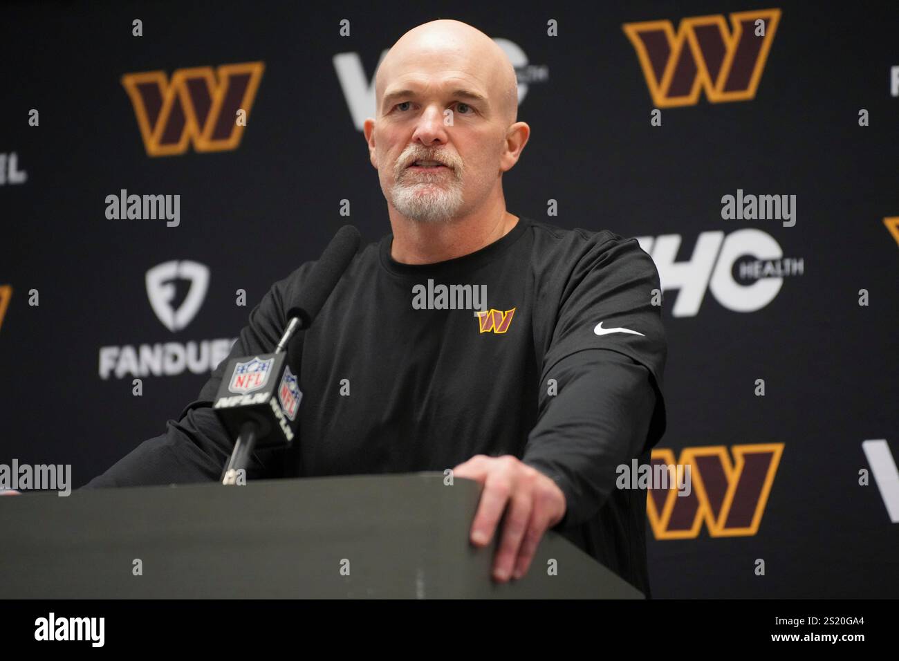 Washington Commanders head coach Dan Quinn talks to reporters following ...