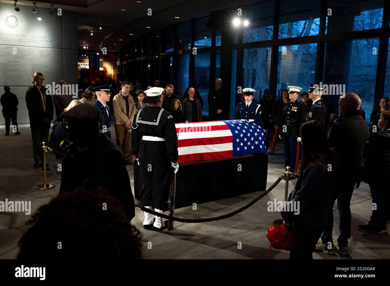 Mourners view the casket of former President Jimmy Carter as he lies in ...