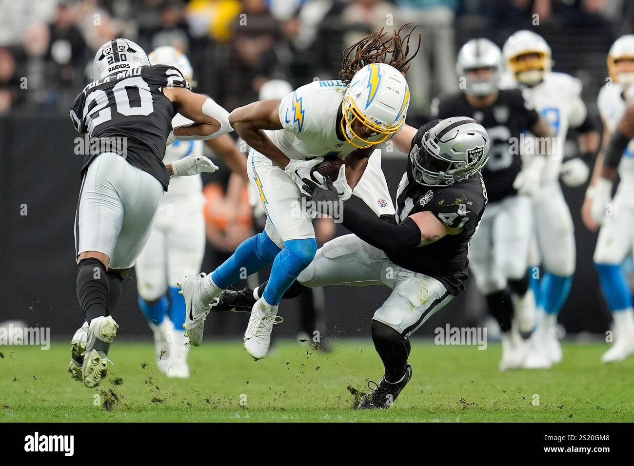 Los Angeles Chargers wide receiver Quentin Johnston, middle, runs ...