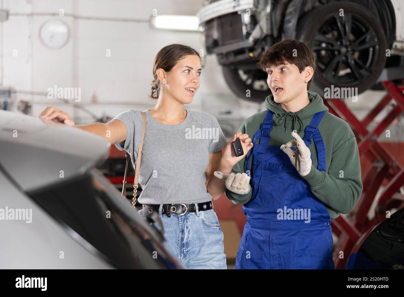 Auto service woman gives keys hi-res stock photography and images - Alamy