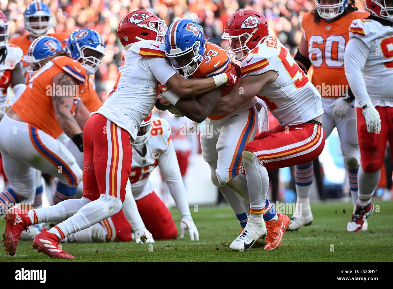 Denver Broncos running back Javonte Williams (33) is stopped by Kansas ...