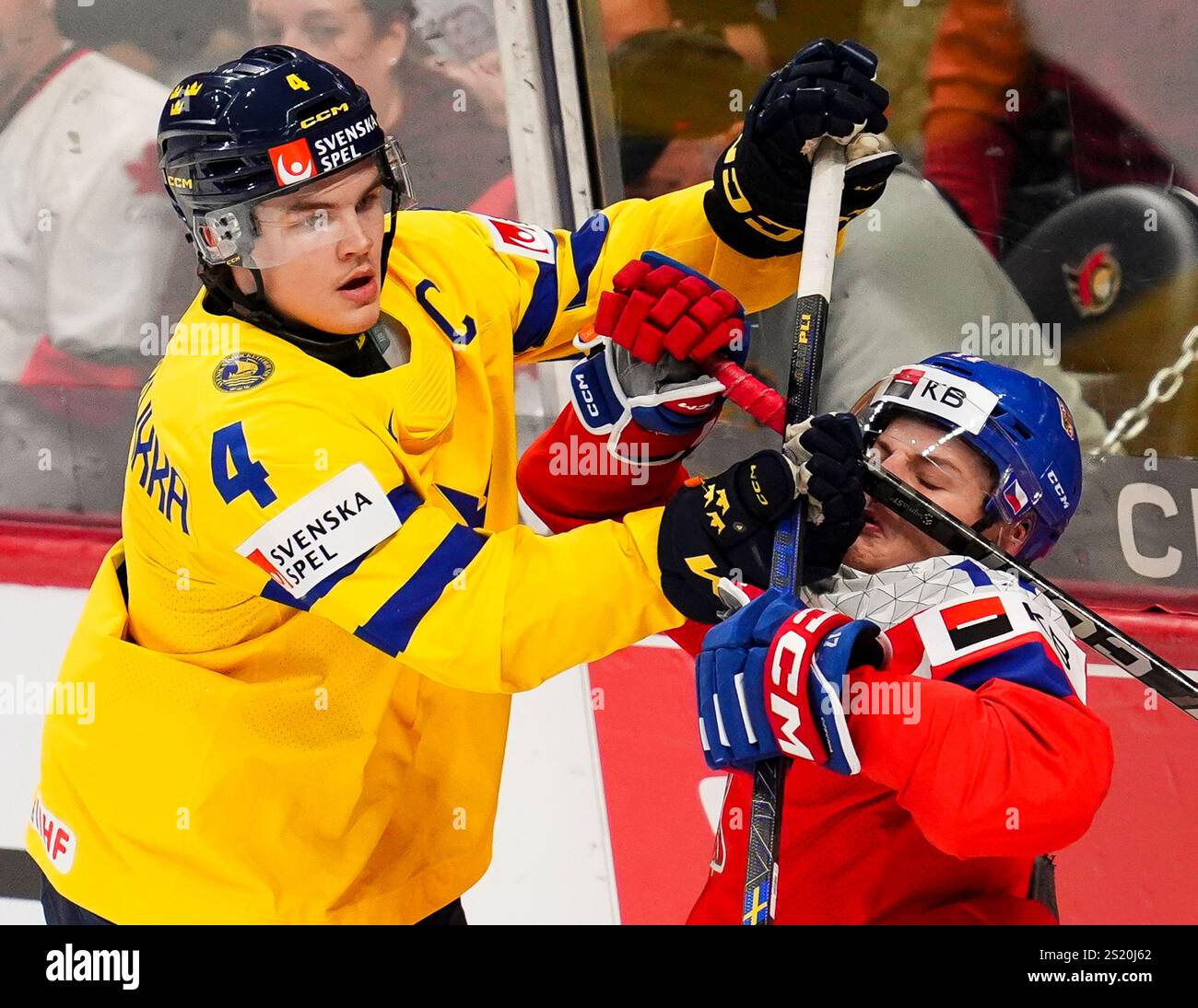 Sweden defenseman Axel Sandin Pellikka (4) gets tangles up with Czechia ...