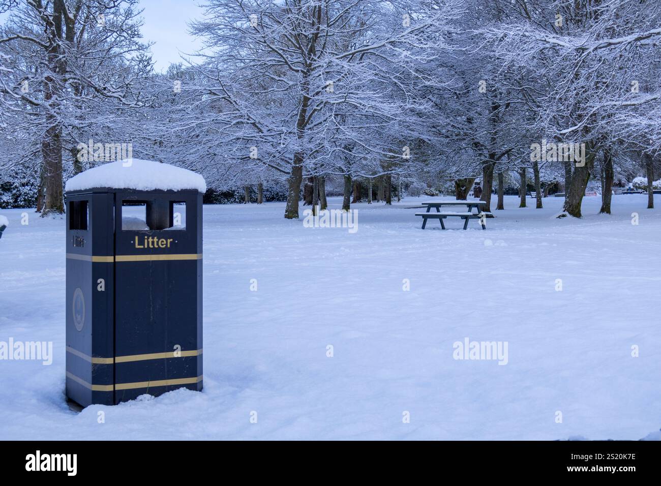 Black litter bin for rubbish collection during the winter in the park ...