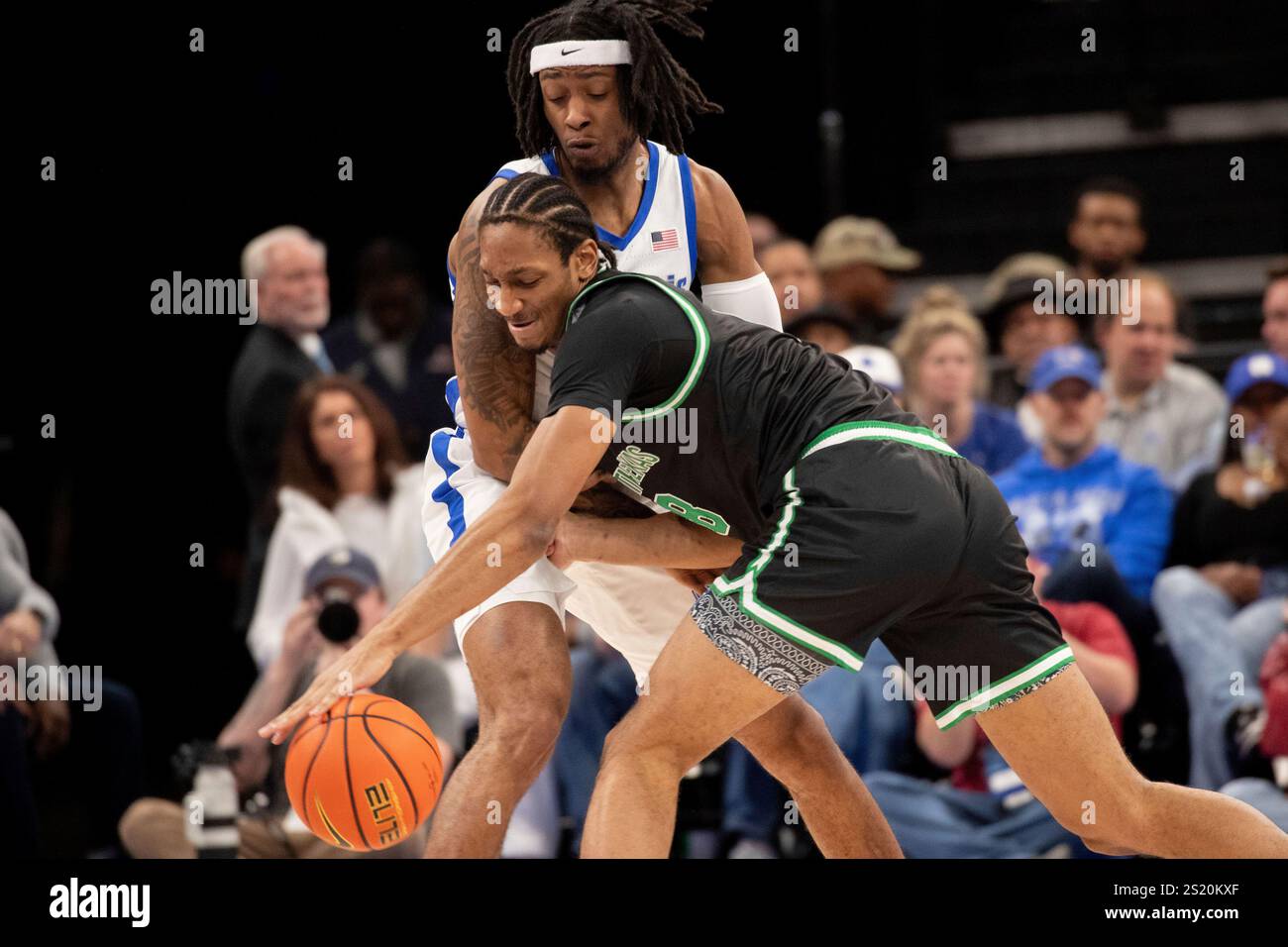 Memphis guard Colby Rogers (3) defends North Texas forward Grant Newell ...