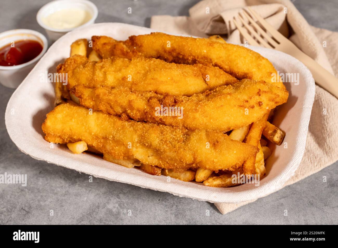 Fish and Chips with tater sauce and ketchup in take out container Stock ...