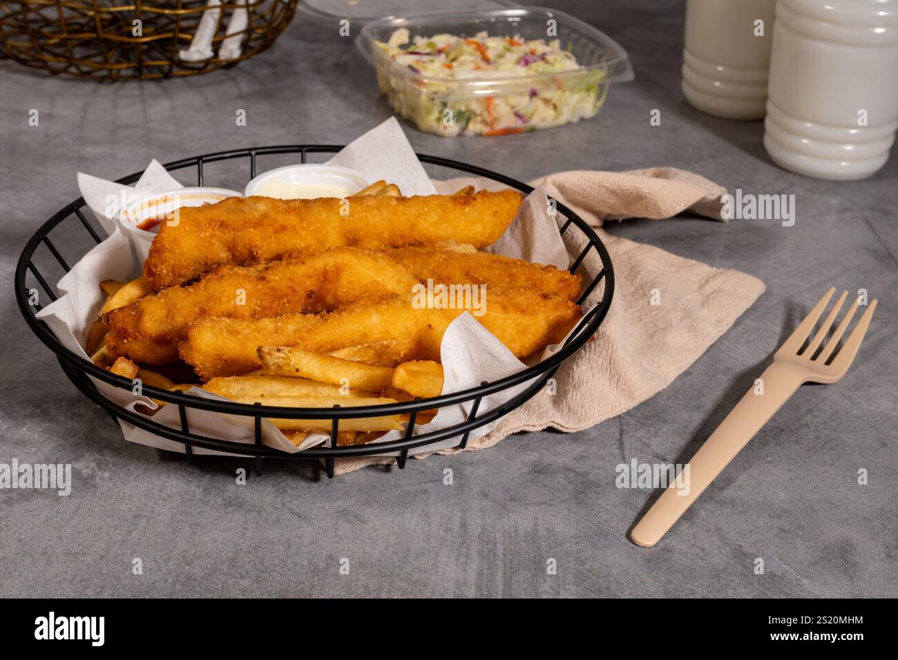 Fish and Chips with tater sauce and ketchup in wire basket Stock Photo ...