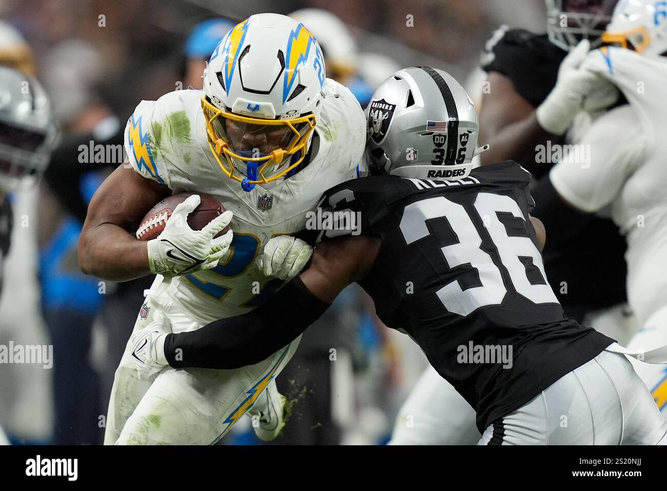 Los Angeles Chargers running back J.K. Dobbins, left, runs against Las ...