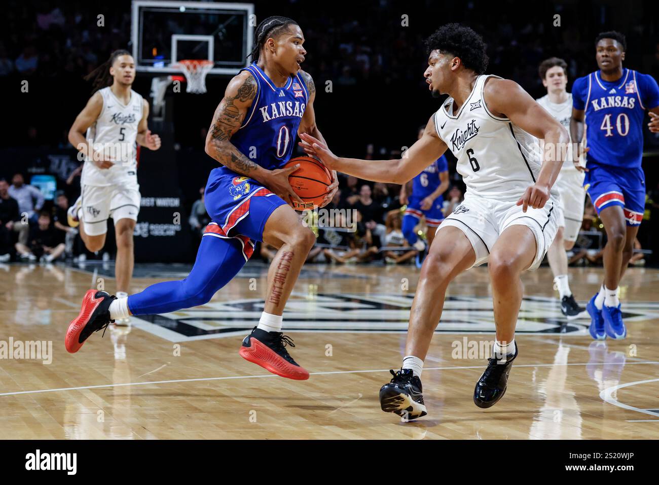 Kansas guard Shakeel Moore (0) drives against Central Florida guard ...