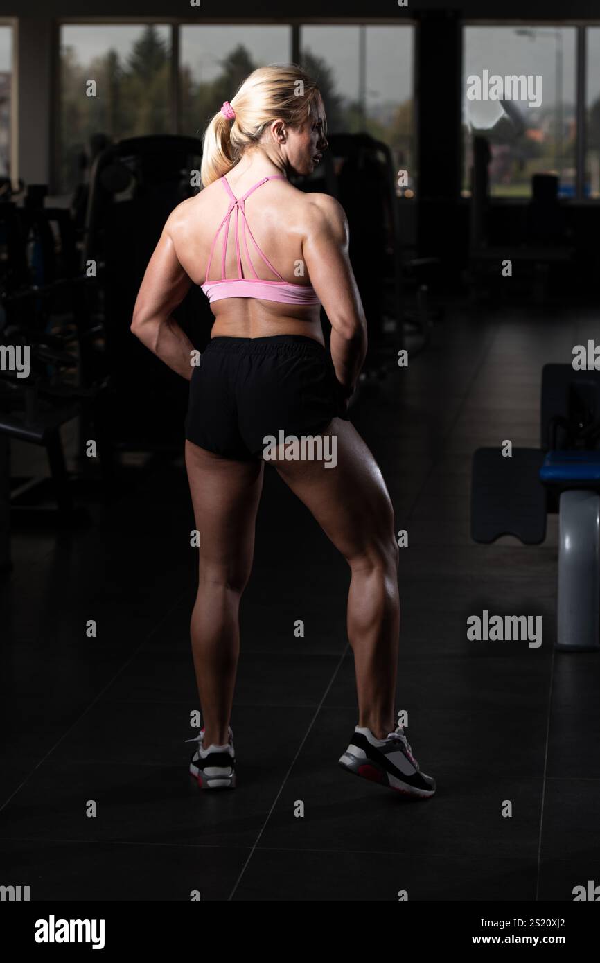 Blonde Woman Posing In A Dark Gym - Perfectly Lit To Showcase Her Toned Muscles And Athletic ...