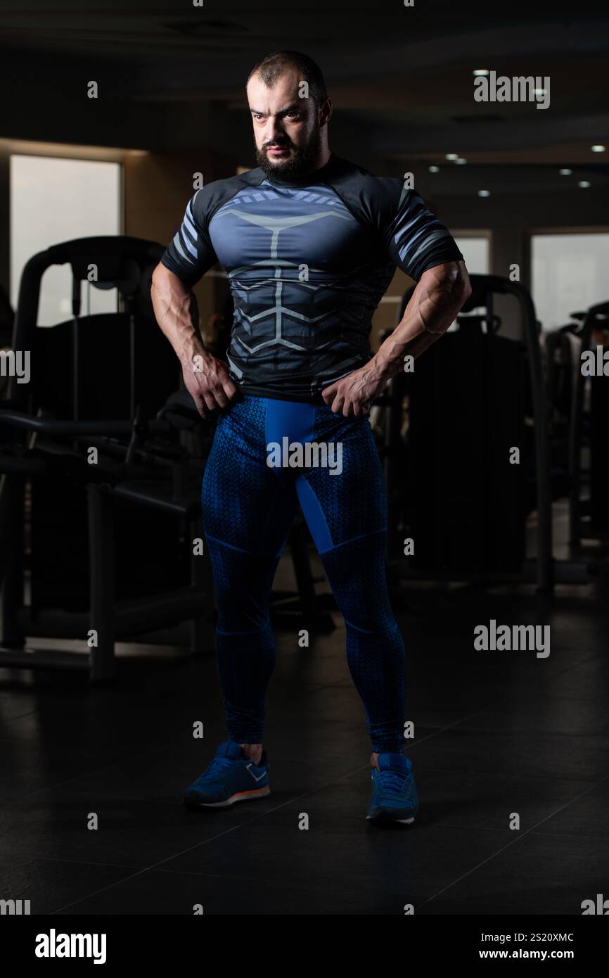 Fit Man Highlighting His Muscular Definition While Posing In Tight-Fit ...