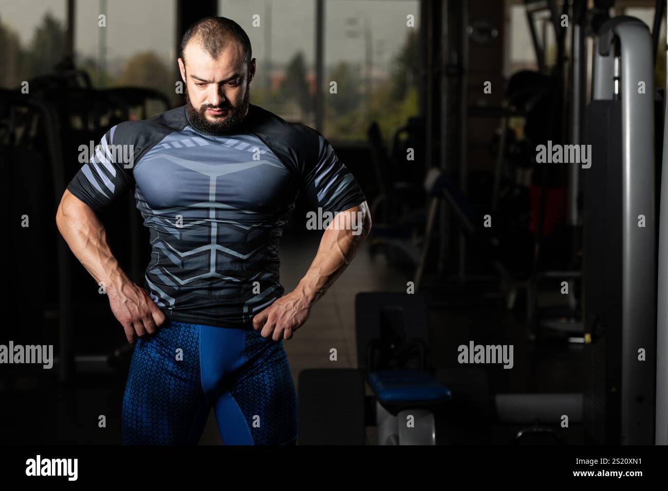 Fit Man Highlighting His Muscular Definition While Posing In Tight-Fit ...