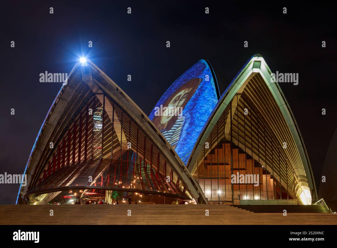 A rear view of the iconic Sydney Opera House with images projected onto ...
