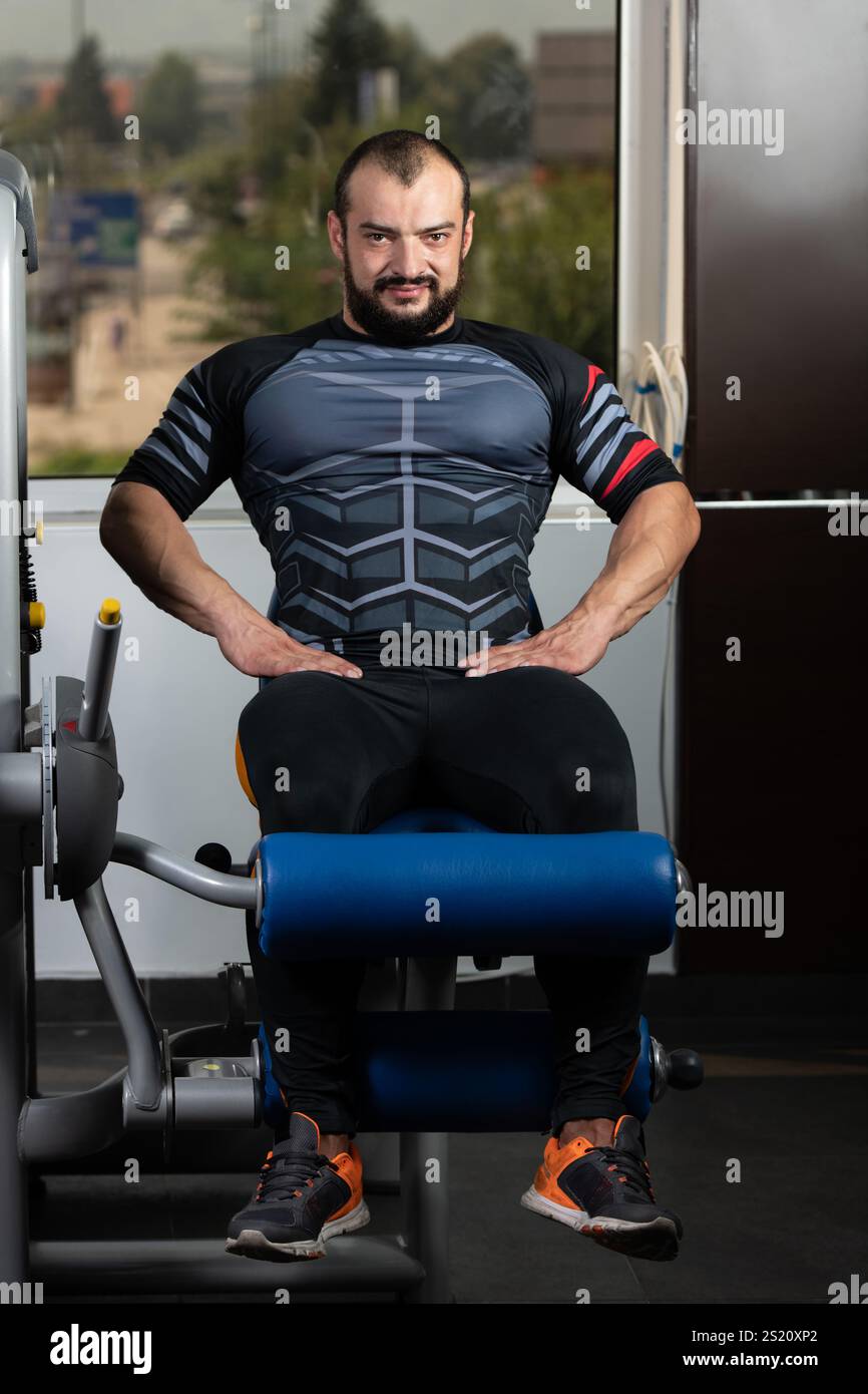 Strong Male Athlete Performing Leg Press Exercises On Machine In The ...