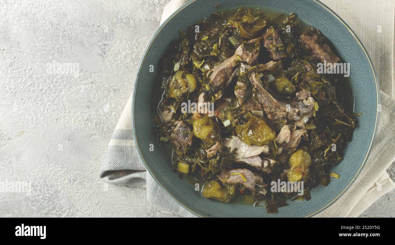Chakapuli, Georgian dish, stewed meat with herbs and tkemali, in white ...