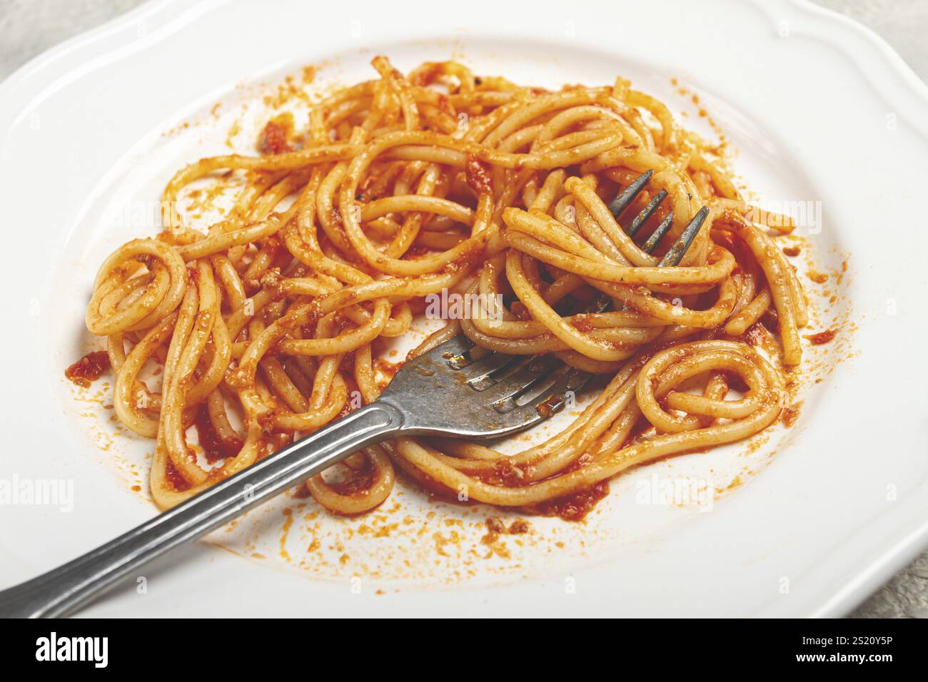 A plate with leftover spaghetti bolognese, no people Stock Photo - Alamy