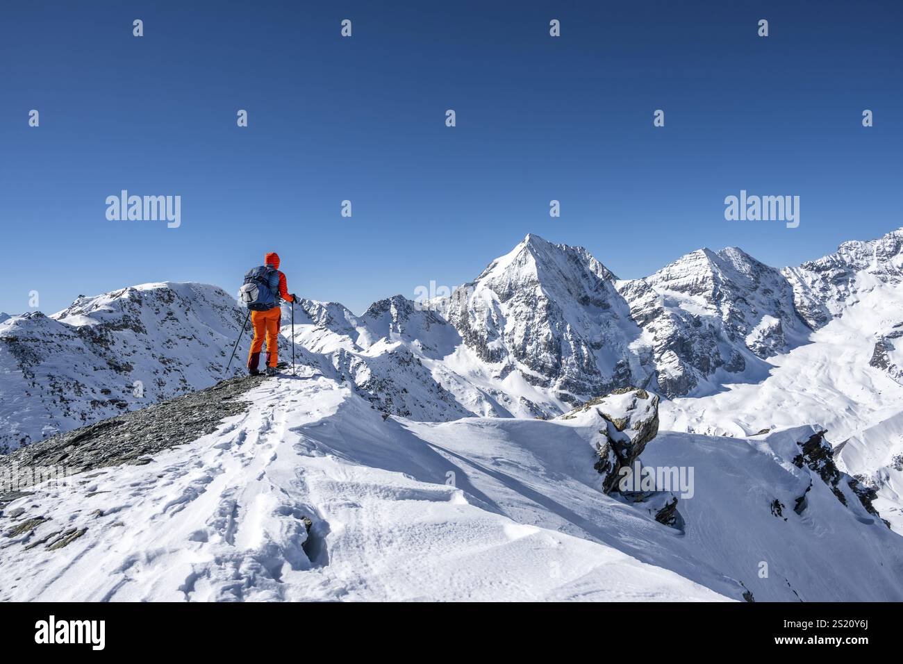 Ski tourers on foot, snow-covered mountain landscape in winter, view of ...