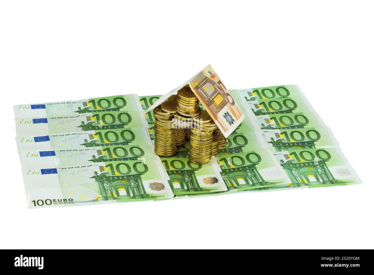 A house made of money coins and banknotes. Symbol photo for house ...