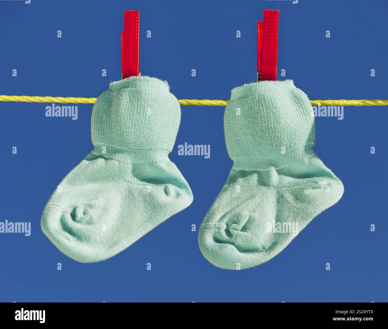 Baby socks on washing line to dry. Blue sky. Austria Stock Photo - Alamy