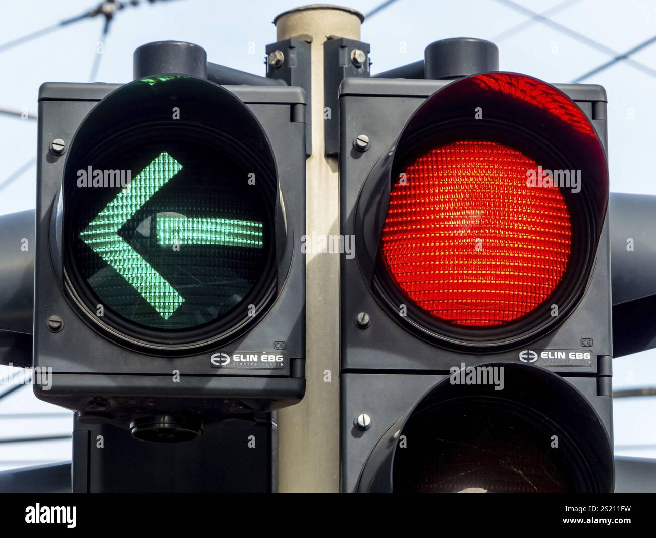 A traffic ramp with a red light. Green light for left turners. Austria ...