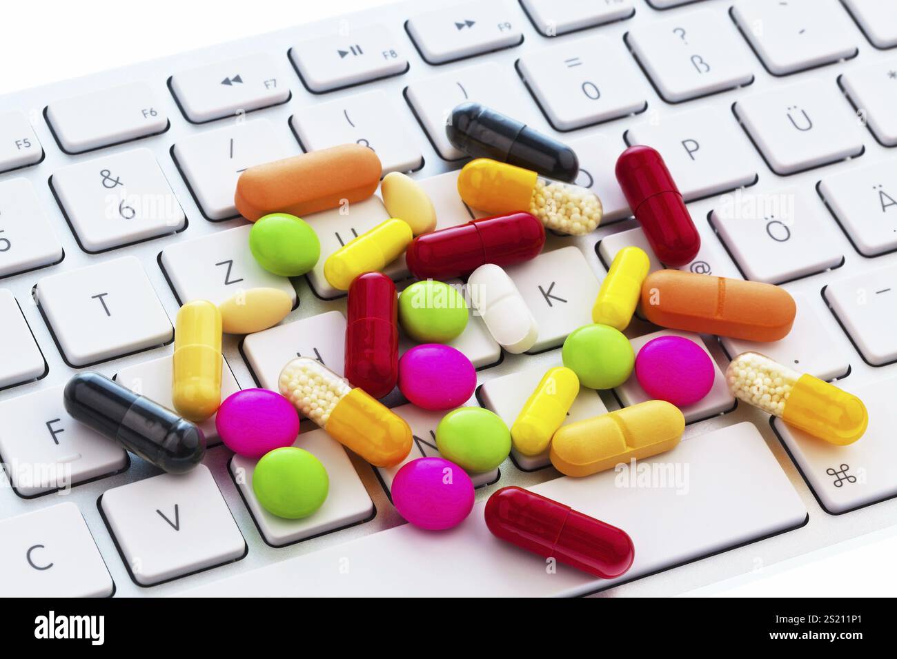 Many tablets and computer keyboard. Symbol photo for online and ...