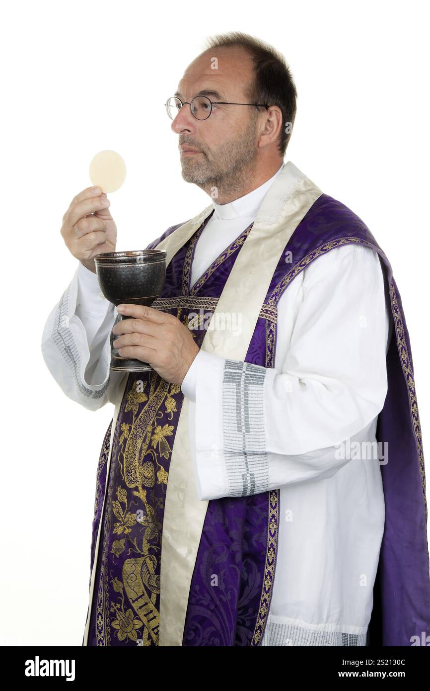 A catholic priest with chalice and host at communion Austria Stock ...