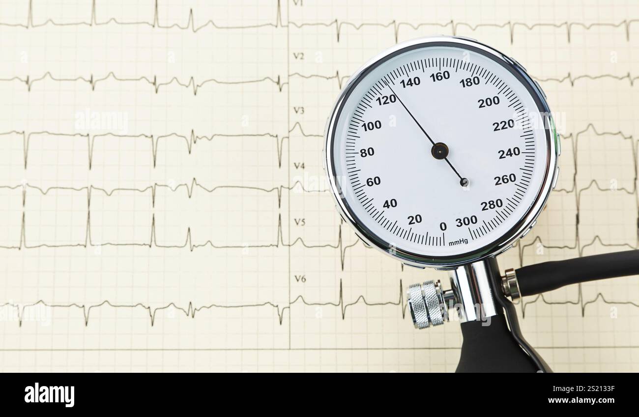A blood pressure monitor and an ECG curve. Hypertension and heart ...