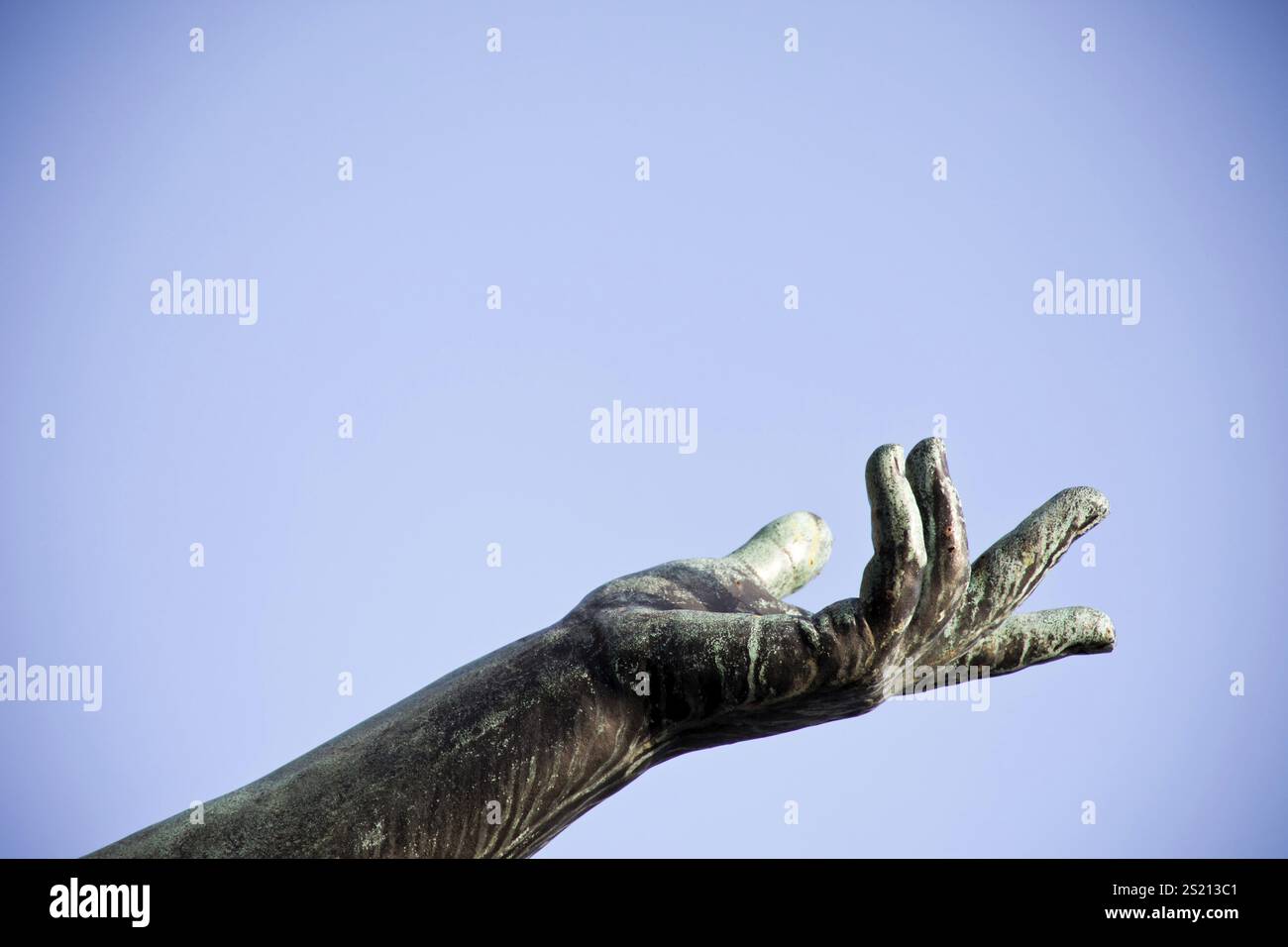 Opened hand of a bronze statue points to the sky Stock Photo - Alamy