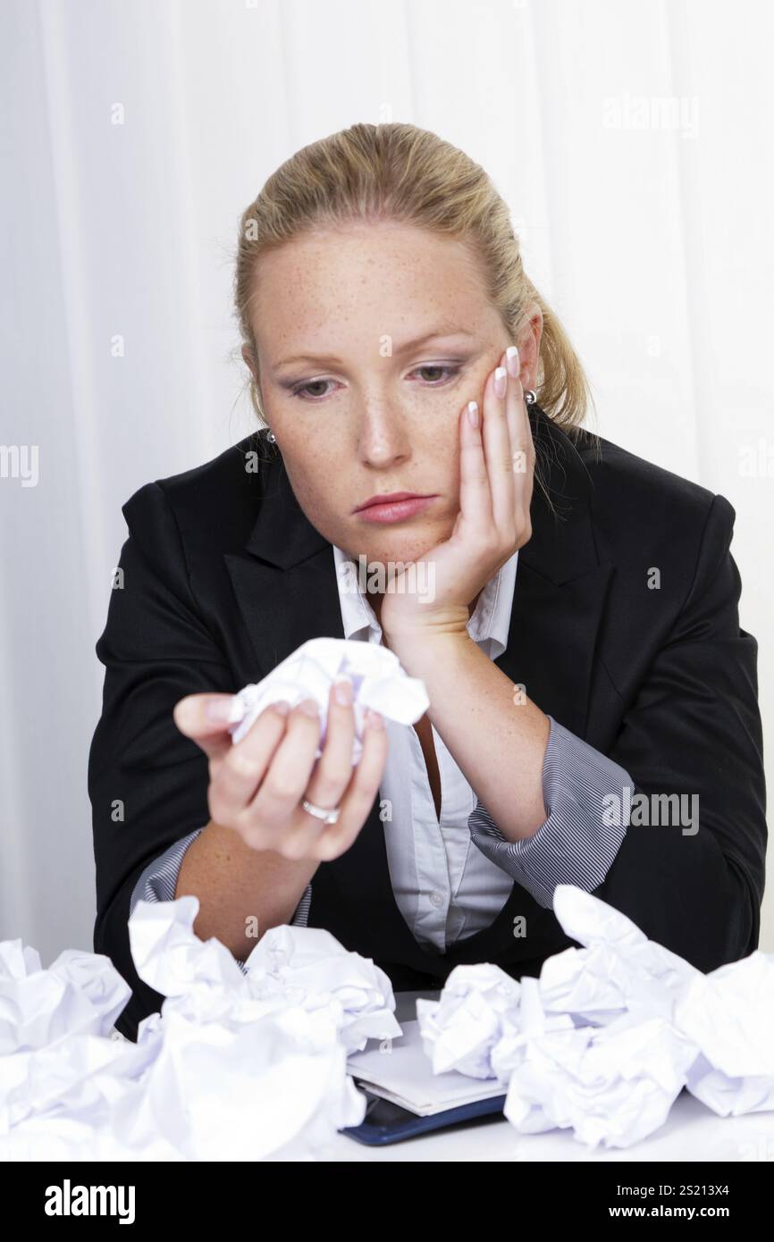 A woman in the office with a ball of paper. Anger, stress and ...
