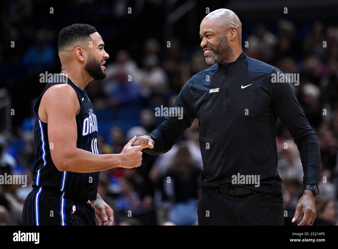 Orlando Magic head coach Jamahl Mosley, right, talks with guard Cory ...