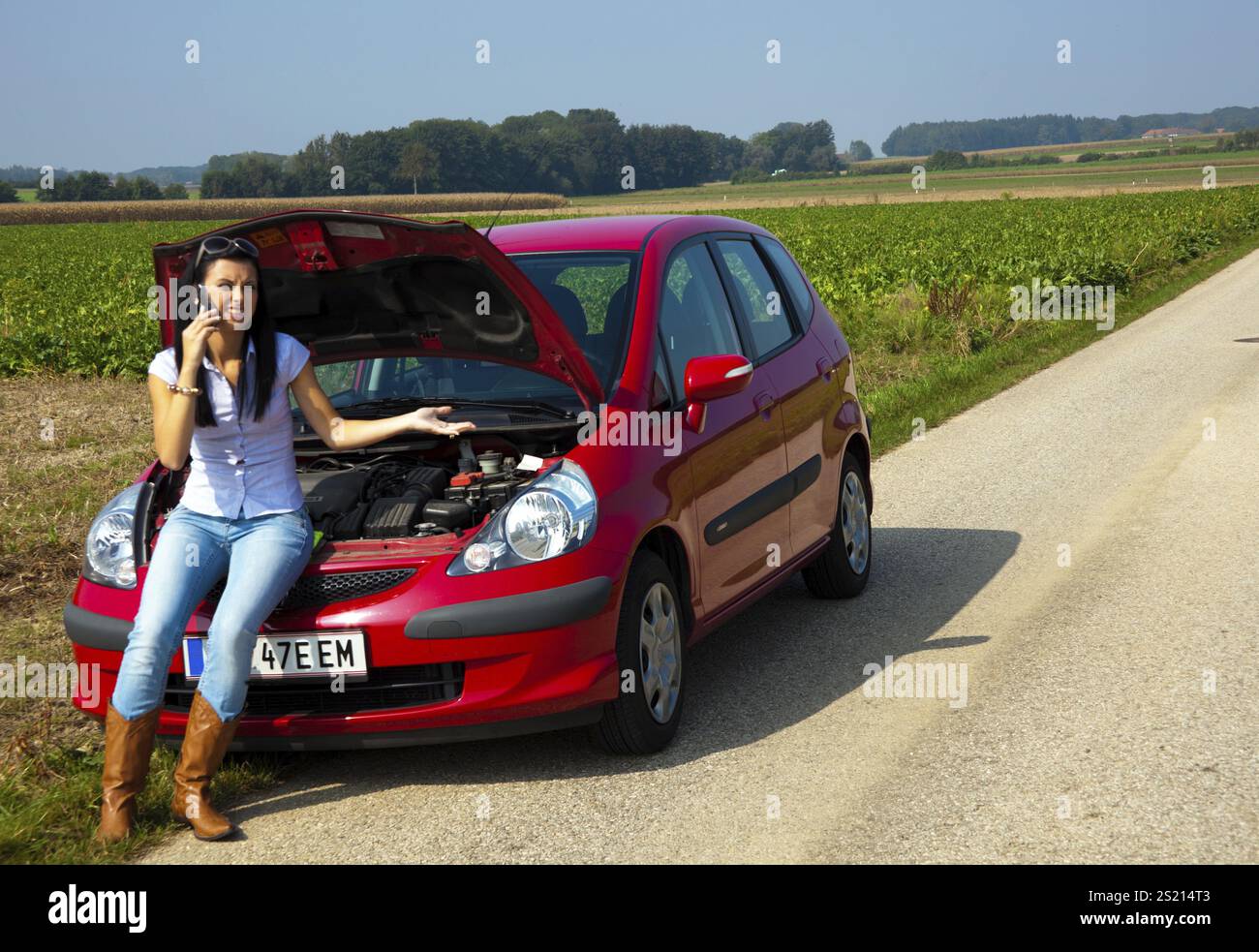 Young woman's car breaks down. Engine failure Stock Photo - Alamy