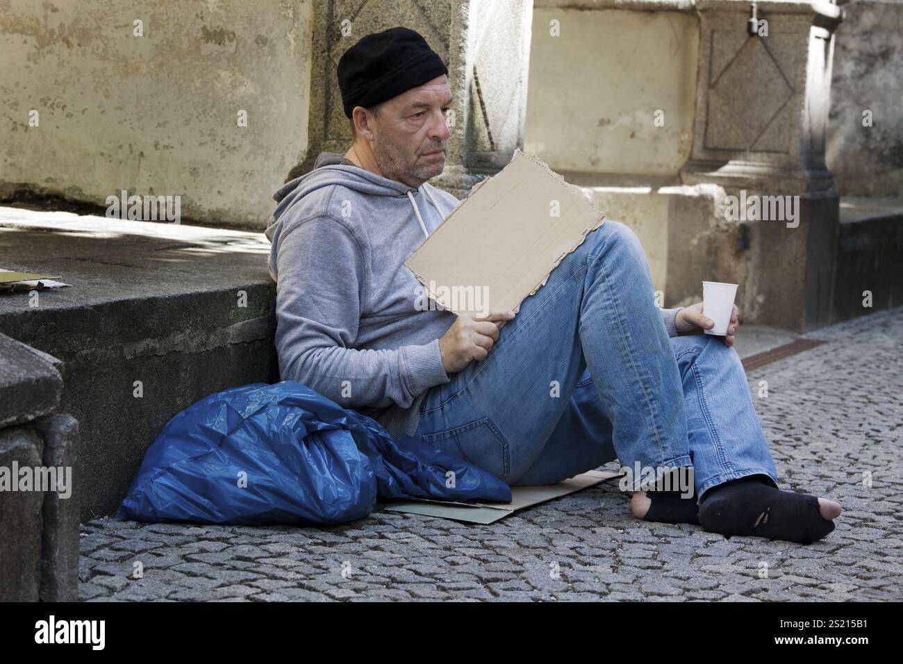 A homeless man seeks new work. Jobless beggar lives on the street ...