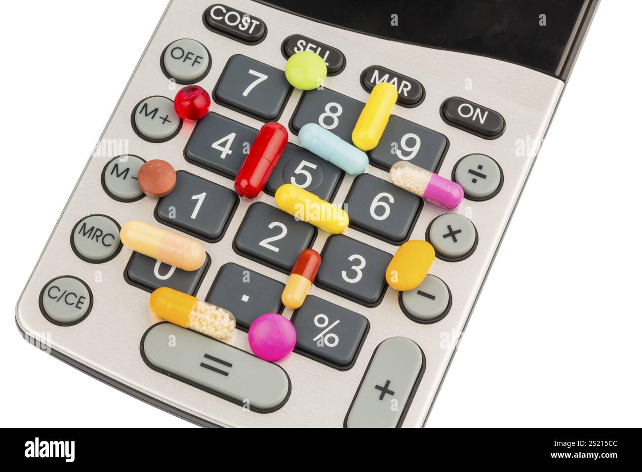Tablets lying on a calculator. Symbol photo for costs in the medical ...