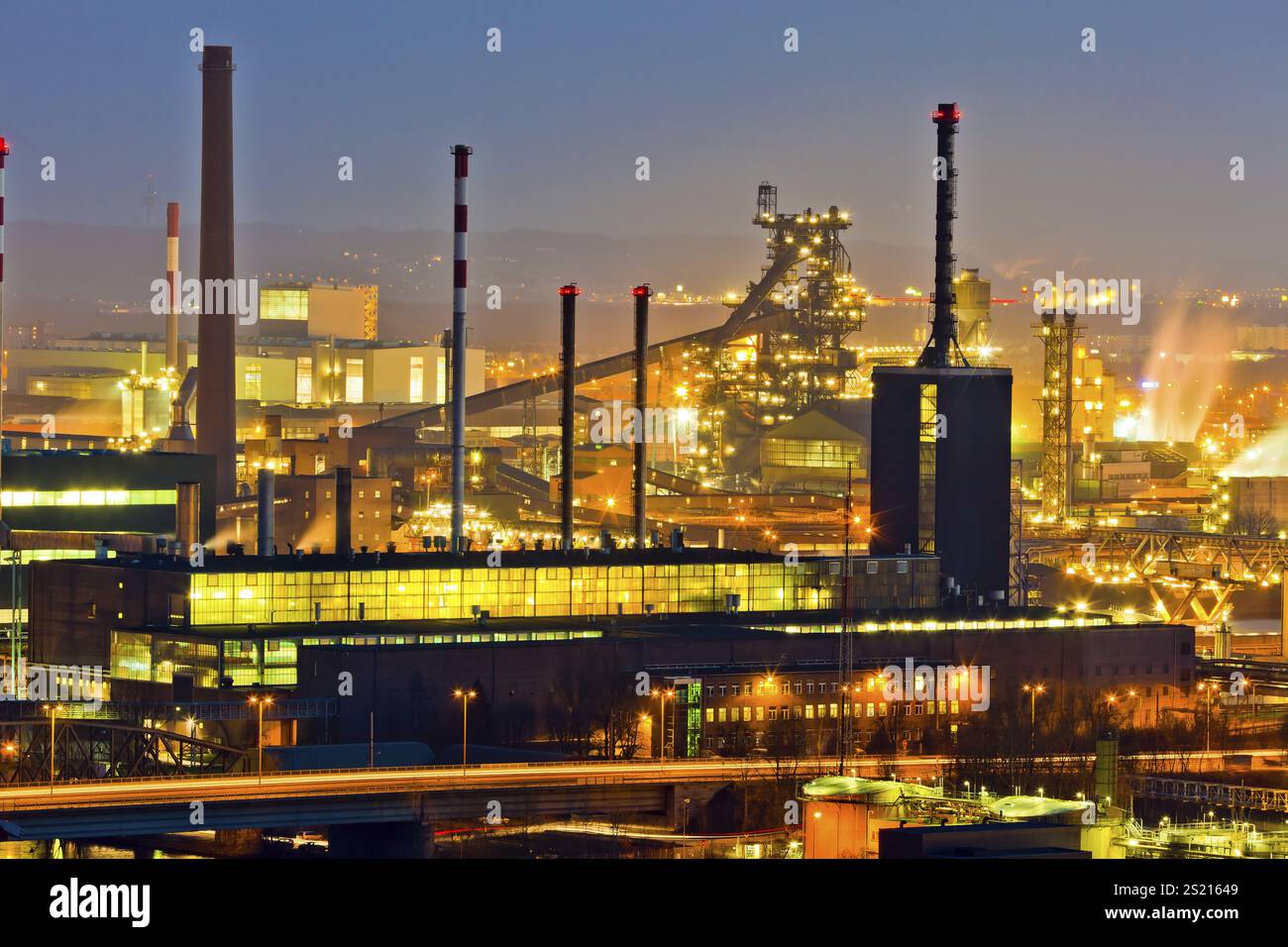 An industrial site of the metal industry in the evening. Lights of ...